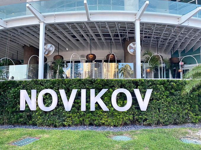 Novikov's sleek exterior beckons with tropical elegance, where Miami modernism meets Asian sophistication beneath swaying palms and Florida sunshine.