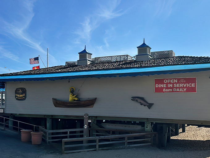 The quintessential pier restaurant experience awaits! Fisherman's weathered white exterior with blue trim and nautical decorations perfectly captures that authentic coastal charm we all crave.