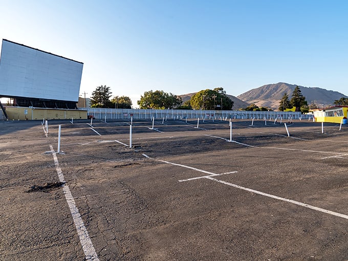 The iconic white screen of Sunset Drive-In stands sentinel against San Luis Obispo's mountain backdrop, waiting for dusk to transform it into a portal of cinematic magic.