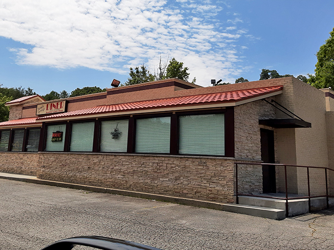 The iconic stone exterior of Sandy Springs Diner stands like a beacon of breakfast hope under Georgia's blue sky, promising comfort food that doesn't need a fancy introduction.