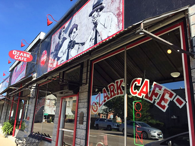 The iconic red and black signage of Ozark Cafe beckons hungry travelers like a lighthouse for comfort food enthusiasts navigating the Ozark Mountains.