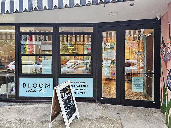 The blue-accented storefront of Bloom Bake Shop beckons like a siren song to carb-lovers. Behind these windows, cookie magic awaits.