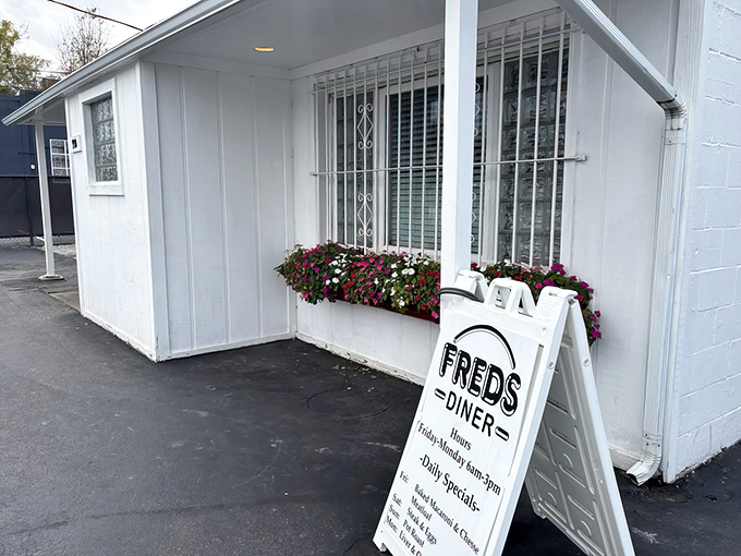 The unassuming white exterior with vibrant flower boxes might fool you, but locals know this modest building houses breakfast magic worth traveling for.