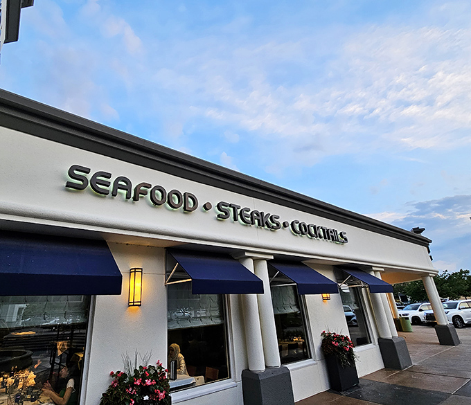 The elegant fa&ccedil;ade of Newport Grill welcomes seafood lovers with its distinctive blue awnings &ndash; a coastal beacon in the heart of Kansas.
