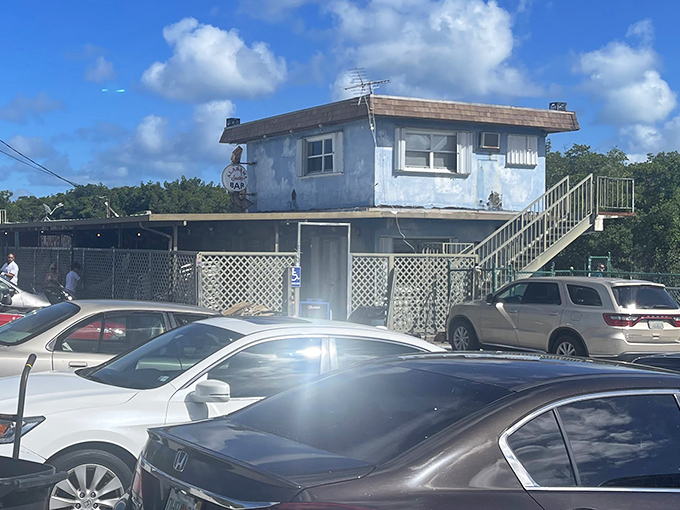 The blue-painted exterior of Alabama Jack's stands like a salty sentinel guarding the gateway to the Keys, promising seafood treasures for those wise enough to stop.