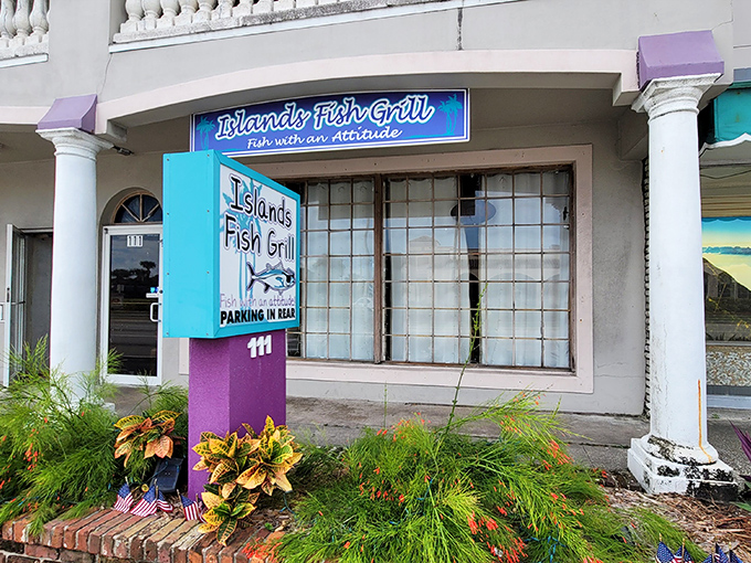 The vibrant turquoise and purple exterior of Islands Fish Grill promises tropical flavors inside &ndash; "Fish with an Attitude" isn't just a slogan, it's a delicious warning.