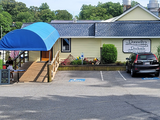 The unassuming yellow exterior of Donnelly's Dockside proves once again that Maryland's best seafood treasures often hide in plain sight. That blue awning practically whispers, "Come on in!"