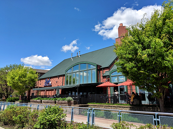 The brick exterior with its distinctive green roof stands proudly along the Christina River, promising seafood treasures within this Wilmington waterfront gem.