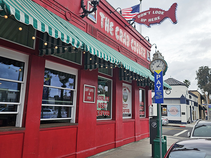 That red exterior isn't just a building—it's a beacon of seafood salvation on Newport Beach's bustling streets. The "Don't Look Up Here" sign? Pure coastal comedy gold.