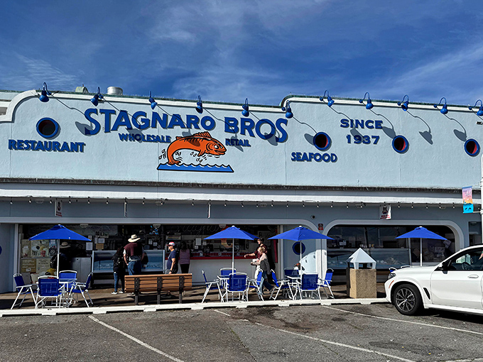 The iconic blue and white exterior of Stagnaro Bros. stands like a beacon at the end of Santa Cruz Wharf, promising seafood treasures within.