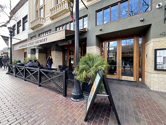 The welcoming storefront of Alvarado Street Brewery beckons passersby with its inviting patio seating and classic Monterey charm. A perfect spot for people-watching while sipping craft beer.