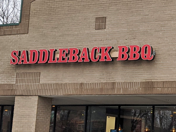 The red letters against beige brick announce "SADDLEBACK BBQ" like a siren song to meat lovers. This unassuming storefront houses barbecue treasures that would make a Texan tip their hat.