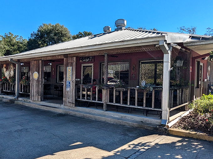 The unassuming exterior of Osteen Diner stands like a time capsule of Old Florida, where weathered wood and metal roofing promise authentic comfort within.