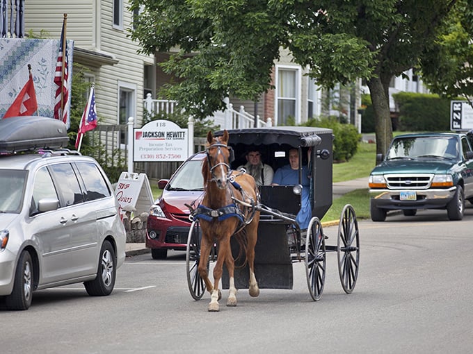 Where past meets present: An Amish buggy navigates Sugarcreek's streets alongside modern vehicles, embodying the town's harmonious blend of worlds.
