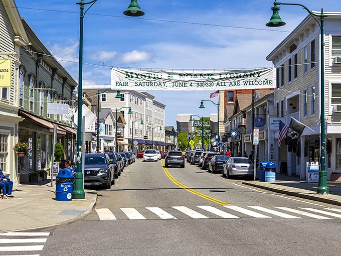 Mystic's charming streetscape welcomes visitors with a banner announcing the town fair &ndash; because in New England, community events still get top billing over chain stores.