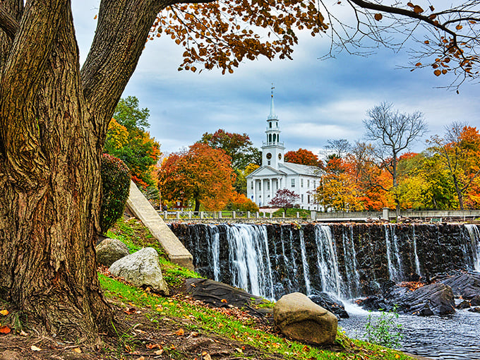 Milford's iconic waterfall and white church steeple create that perfect New England moment where you half expect Paul Revere to gallop through.