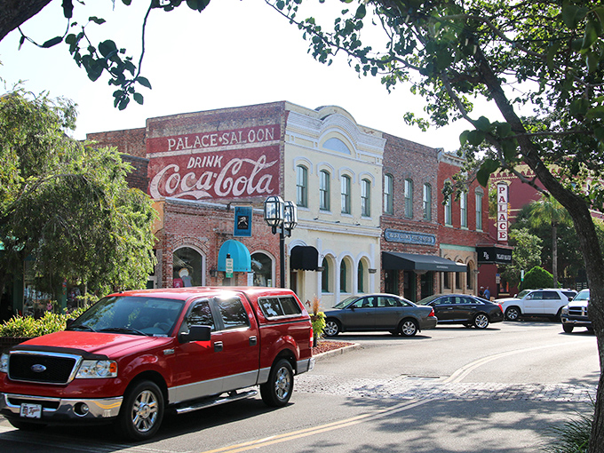 Downtown Fernandina Beach showcases its historic charm with the iconic Palace Saloon's vintage Coca-Cola sign standing proudly against a backdrop of preserved Victorian architecture.