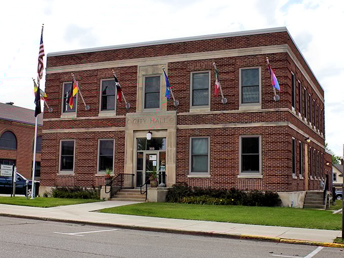 Worthington's City Hall stands proudly with international flags waving, a brick-and-mortar testament to small-town governance with global awareness.