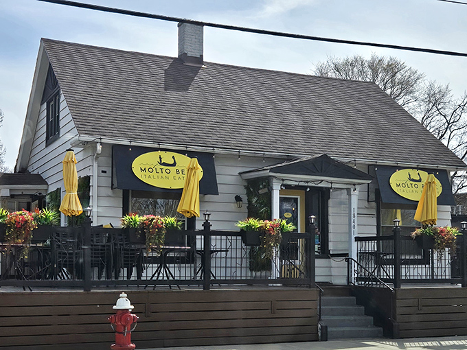 Molto Bene's charming cottage exterior feels like stumbling upon a secret Italian hideaway. Those yellow umbrellas practically whisper, "Come in, we've been expecting you."
