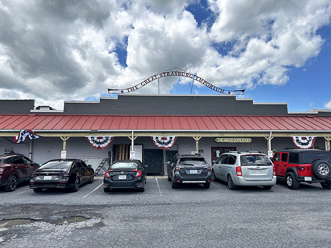 The Great Strasburg Emporium welcomes treasure hunters with its distinctive red-roofed facade and patriotic bunting, like a carnival barker from a more charming era.