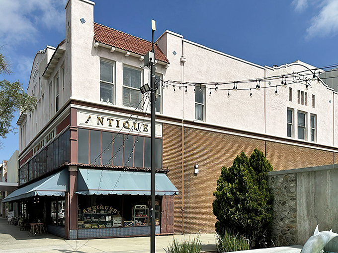 A corner view reveals the architectural charm of this vintage hunter's paradise. String lights hint at the magic that awaits, while the Spanish-style roof tiles whisper stories of California's past.