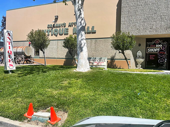 The beige fa&ccedil;ade of Granny's Attic Antique Mall stands like a portal to the past, complete with vintage wagon and grassy welcome area.
