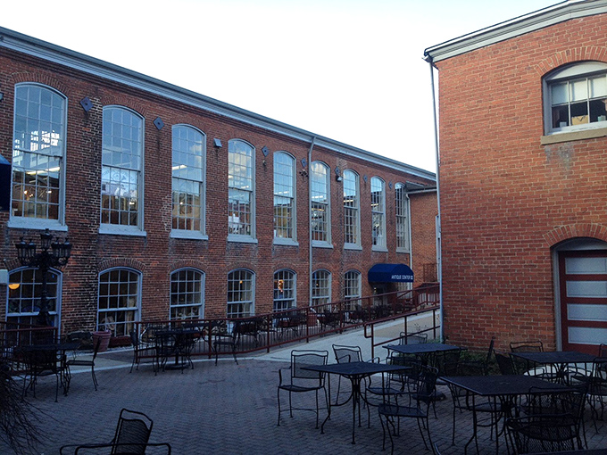 The historic brick exterior of Savage Mill stands as a testament to Maryland's industrial past, now housing treasures instead of textiles.