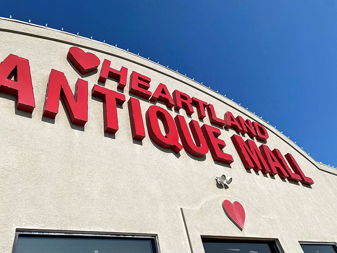 The curved roofline and bold red lettering against the cream-colored facade create that perfect "I've got to see what's inside" moment every antique enthusiast lives for.