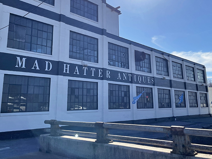 The white industrial facade of Mad Hatter Antiques belies the wonderland within&mdash;like a nondescript book hiding the most fantastical story. 