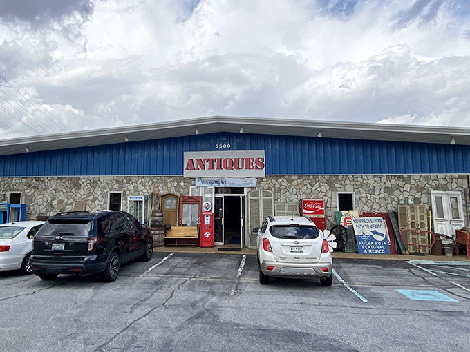 The blue-roofed time capsule beckons with its stone facade and vintage Coca-Cola machine standing guard. History's waiting room has plenty of parking.