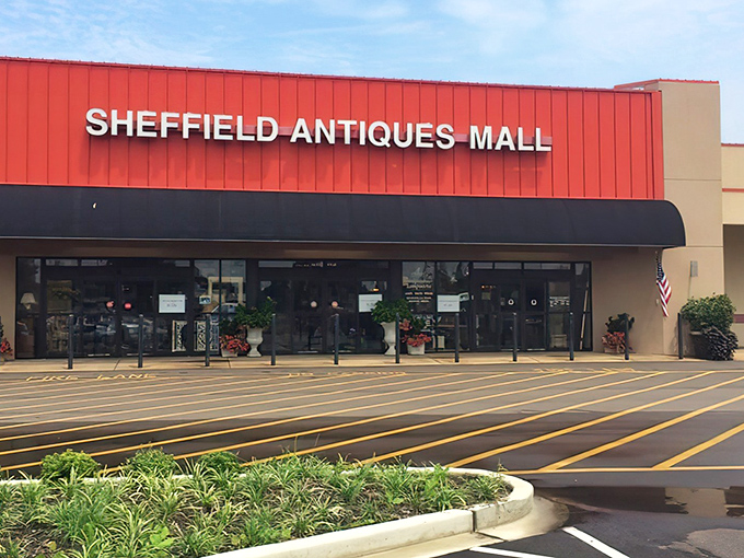 The iconic red roof of Sheffield Antiques Mall beckons treasure hunters like a lighthouse for vintage enthusiasts navigating the sea of mass-produced sameness.