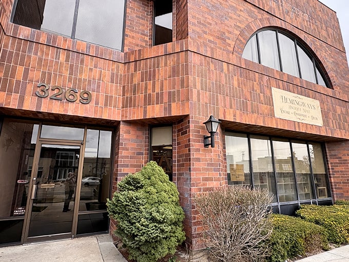 The distinctive brick facade of Hemingways Antique Mall beckons treasure hunters with its vintage charm and architectural character.