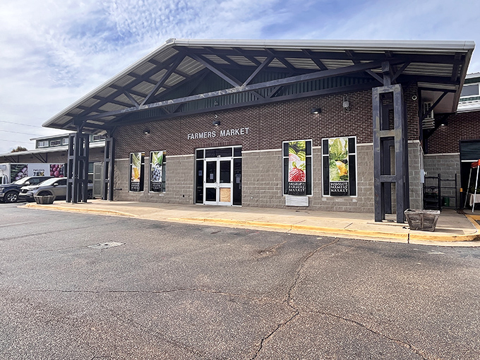 The welcoming facade of Mississippi Farmers Market stands ready for Saturday morning treasure hunters, its brick and concrete exterior hiding a world of culinary wonders within.