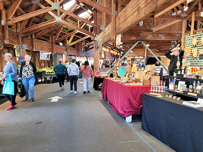 The timber-framed wonderland where shopping feels like a treasure hunt through Pacific Northwest bounty. Sunlight streams through rafters onto displays of local delights.