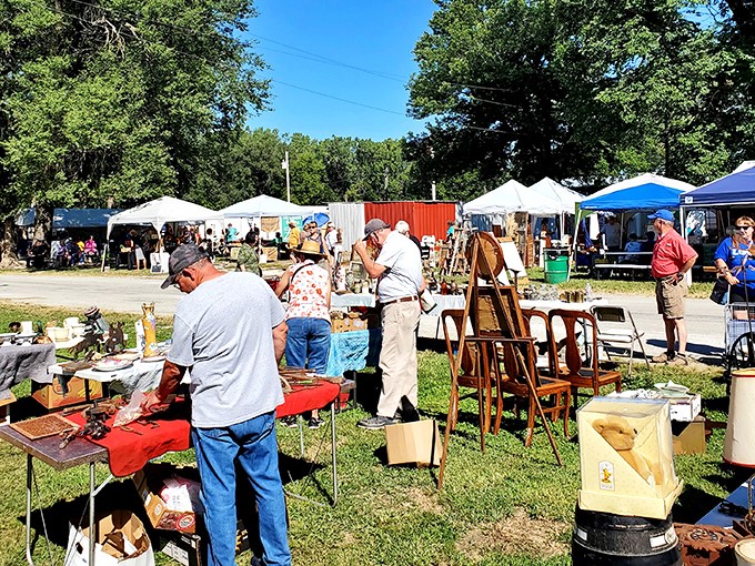 Treasure hunters in their natural habitat! Shoppers browse furniture, collectibles, and curiosities under a canopy of Kansas sky at Sparks Flea Market.