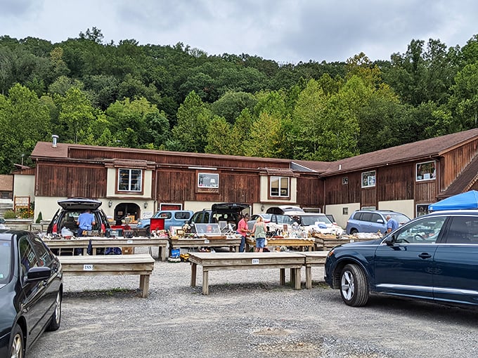The rustic wooden buildings of Golden Nugget Antique Flea Market nestle against New Jersey greenery, promising treasures within their weathered walls.