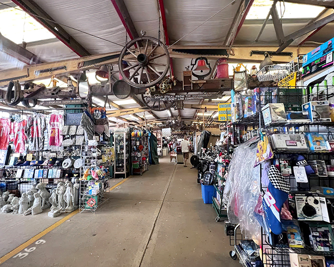 Americana heaven! Wagon wheels and vintage treasures dangle from the ceiling while shoppers navigate aisles packed with everything from garden statues to racing flags.