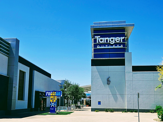 The iconic blue Tanger sign welcomes bargain hunters like a retail lighthouse guiding ships to discount shores.