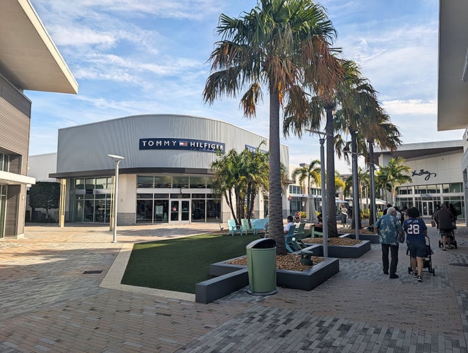 Tommy Hilfiger stands tall among palm trees, promising preppy paradise at prices that won't require a second mortgage.