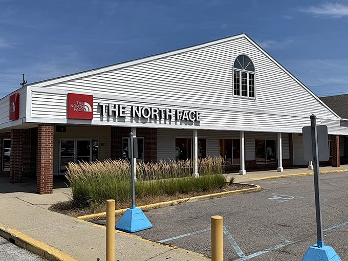 The North Face outlet beckons with its classic white clapboard design. Outdoor adventure gear without the "I need a second job" price tags.