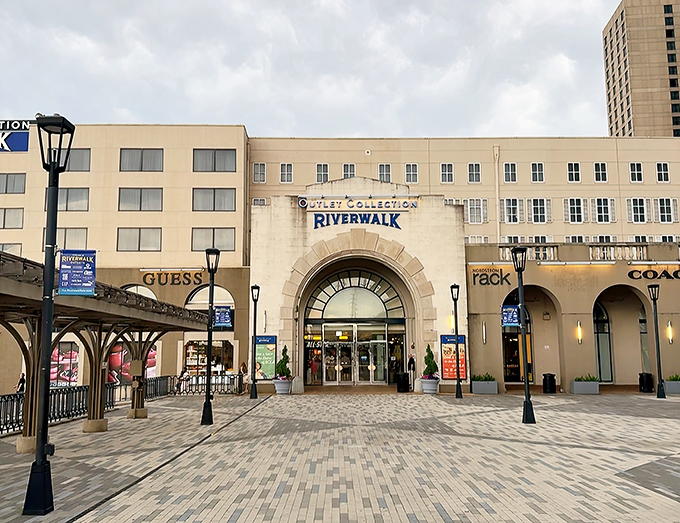 The grand entrance to Riverwalk beckons shoppers with its elegant archway and classic New Orleans-inspired architecture. Retail therapy with a side of southern charm.