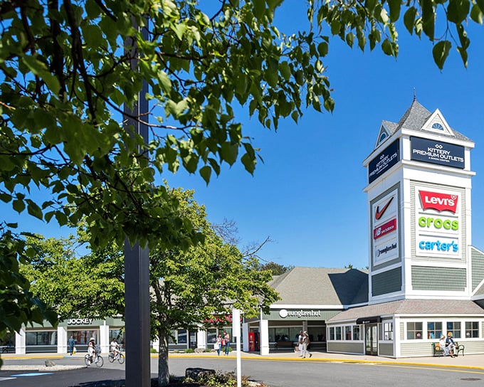 The iconic Kittery Premium Outlets tower stands tall against Maine's blue sky, a beacon calling to bargain hunters like a retail lighthouse.
