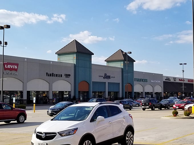 The iconic mint-green tower of Tanger Outlets stands against a perfect blue Missouri sky, promising retail adventures and wallet-friendly treasures within.