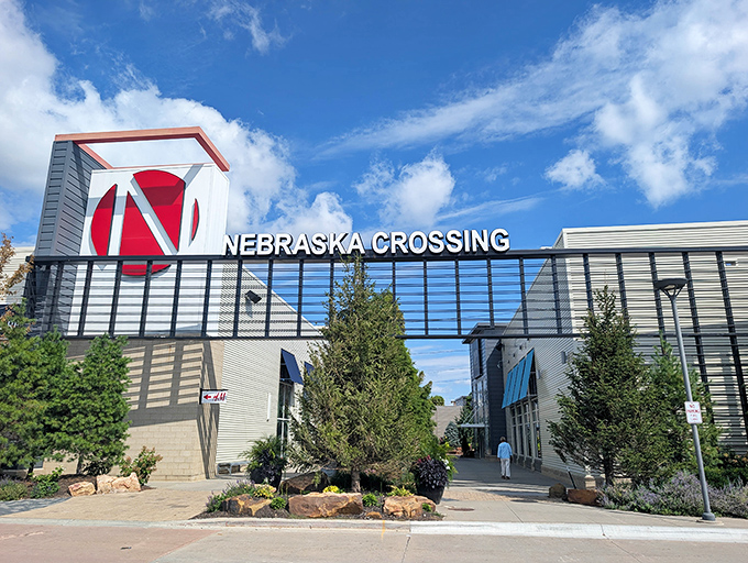 The iconic red "N" logo of Nebraska Crossing stands tall against Nebraska's big blue sky&mdash;retail therapy's bat signal for serious shoppers everywhere.