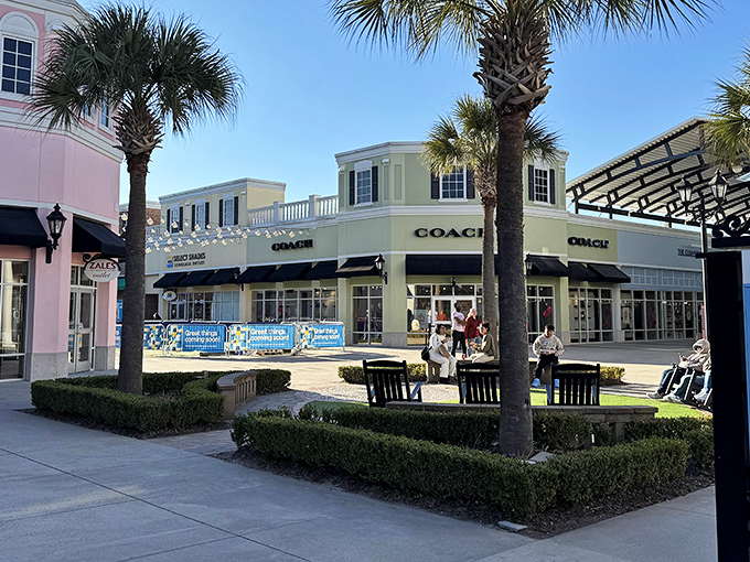 The Lowcountry architecture of Tanger Outlets Charleston welcomes shoppers with palm trees and elegant cupolas, promising retail therapy with Southern charm.