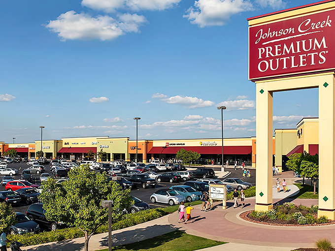 The iconic burgundy sign welcomes shoppers to retail paradise. Like a beacon of bargains calling to credit cards everywhere.