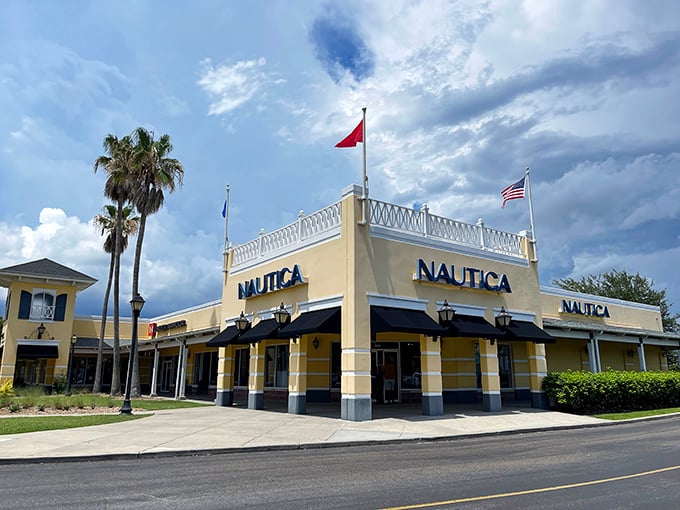 The Nautica store stands like a coastal captain's quarters, complete with nautical flags fluttering above. Shopping here feels like setting sail on a sea of savings.