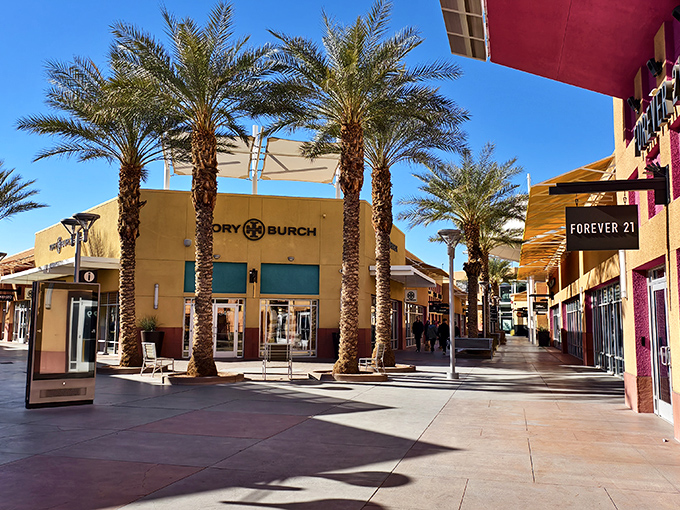 Palm trees frame designer storefronts at Las Vegas North Premium Outlets, where bargain hunting feels like a luxury experience without the luxury price tag.
