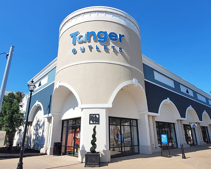 The iconic cylindrical entrance to Tanger Outlets stands like a retail lighthouse, beckoning bargain hunters to the shores of discount paradise.