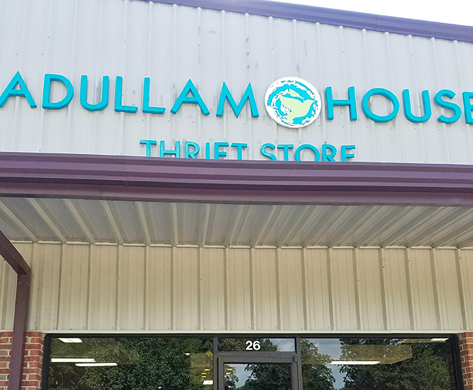 The turquoise lettering against white metal siding isn't just signage&mdash;it's an invitation to the treasure hunt waiting inside Adullam House Thrift Store in Wetumpka.
